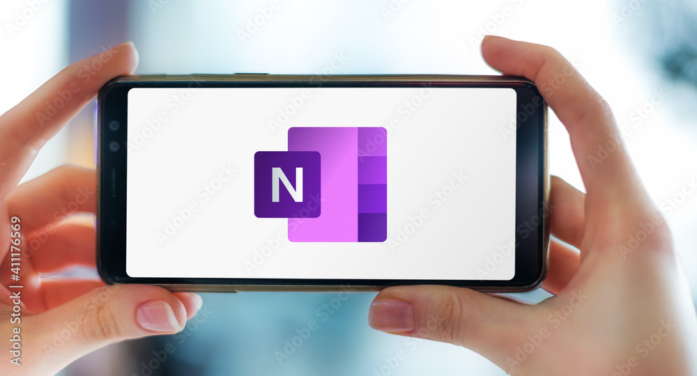 Hands holding smartphone displaying logo of Microsoft OneNote foto de ...