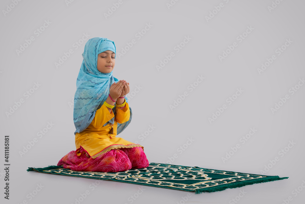 Young Muslim girl wearing hijab reciting namaz on the occasion of eid ...