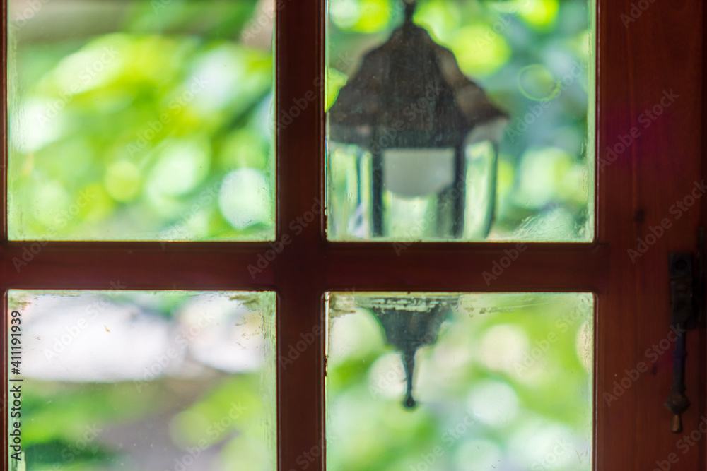 isolated authentic window crossed by a vintage looking ceiling lamp ...