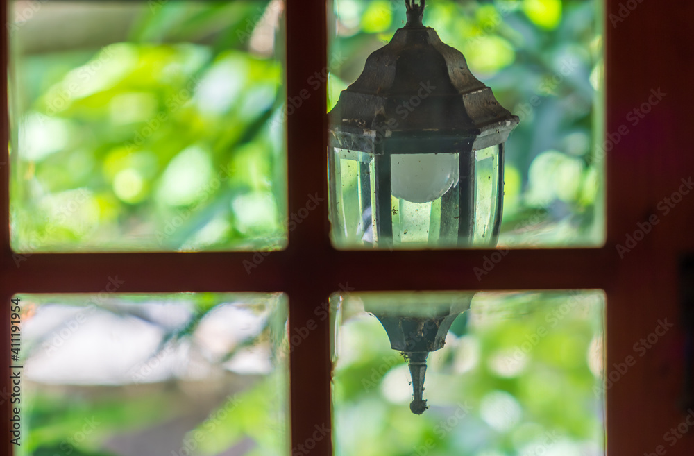 isolated authentic window crossed by a vintage looking ceiling lamp ...