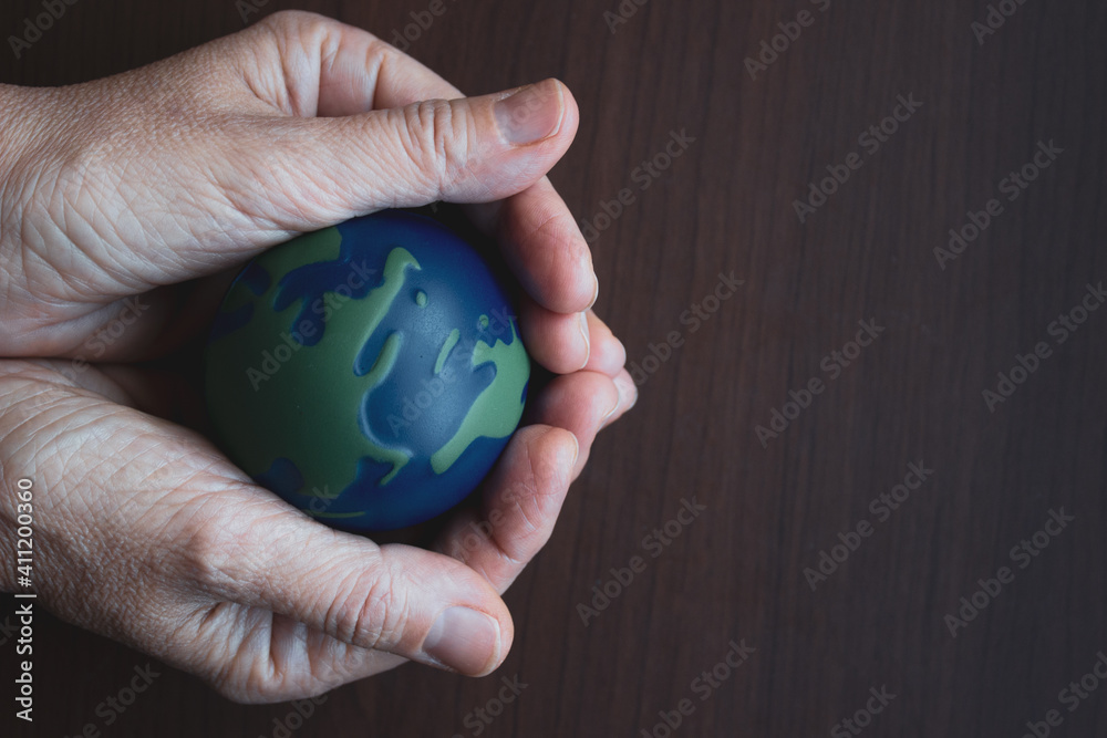 Earth Day. Male hand holding earth in his hands. Human saving planet ...