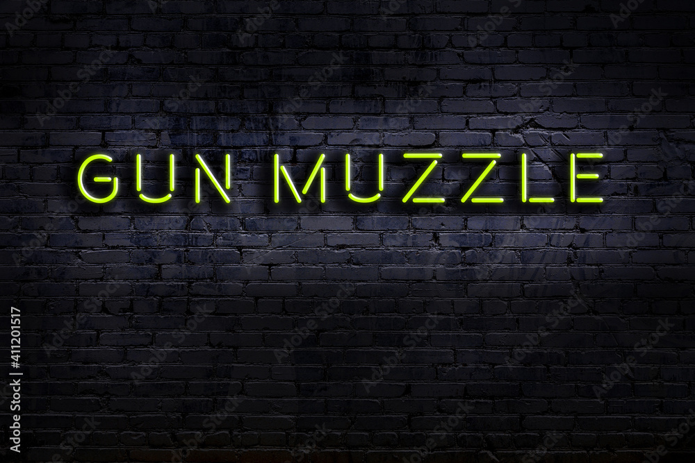 Neon sign. Word gun muzzle against brick wall. Night view Stock ...