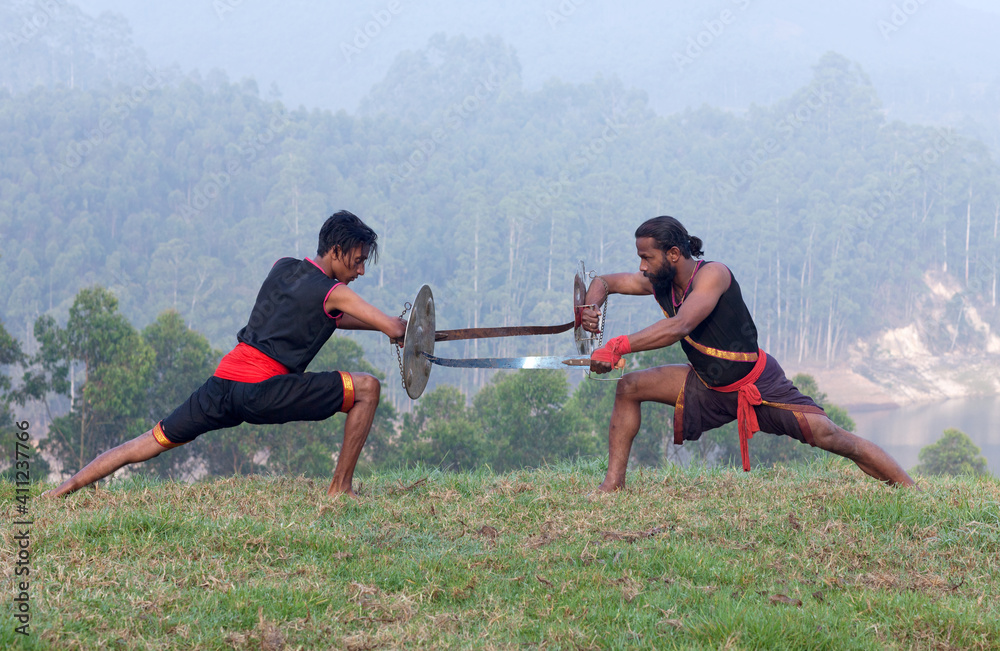 Indian fighters with sword and shield performing weapon combat during ...