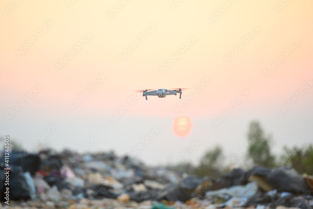 Flying drone pilots take pictures of the garbage pile. To explore the ...