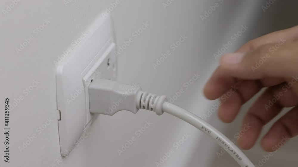 Hand remove Electric plug on socket. Electrical equipment, electrical ...