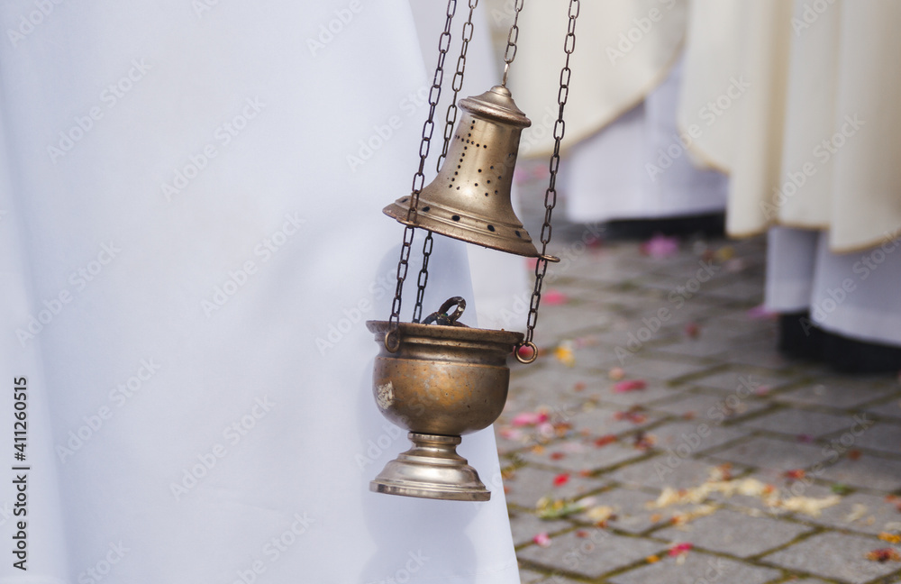 Priest holding Catholic thurible during the Feast of Corpus Christi ...