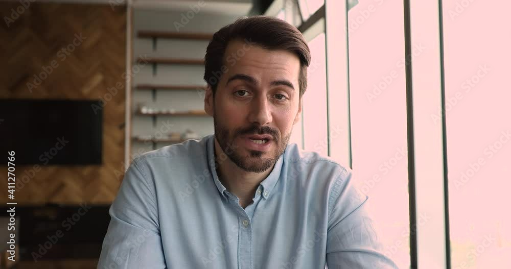 Confident skilled young man looking at camera, talking recording ...