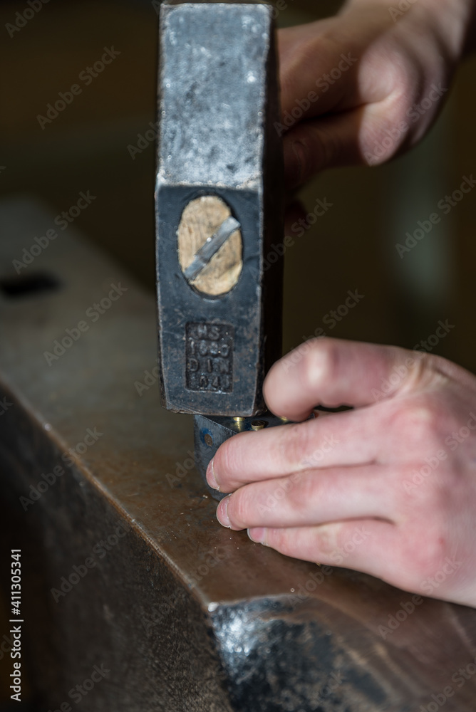 Mit Hammer und Metall am Amboss - Detail Stock Photo | Adobe Stock
