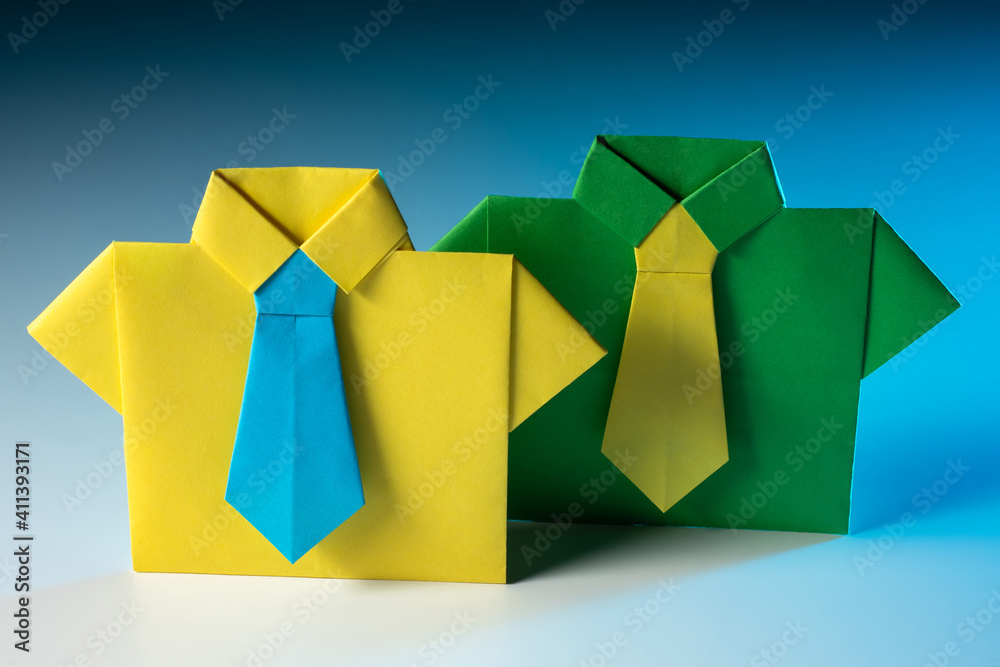 Two shirts made of paper as a symbol of partnership in business. Two ...