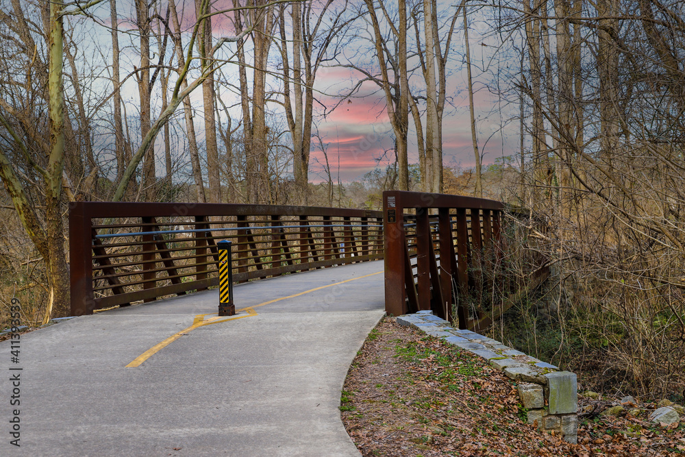 a long brown and yellow iron bridge with smooth concrete pavement across the bridge at Tanyard ...