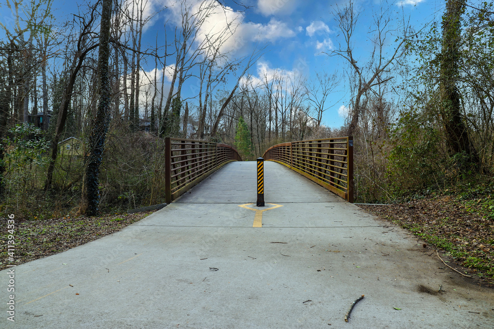 a long brown and yellow iron bridge with smooth concrete pavement ...