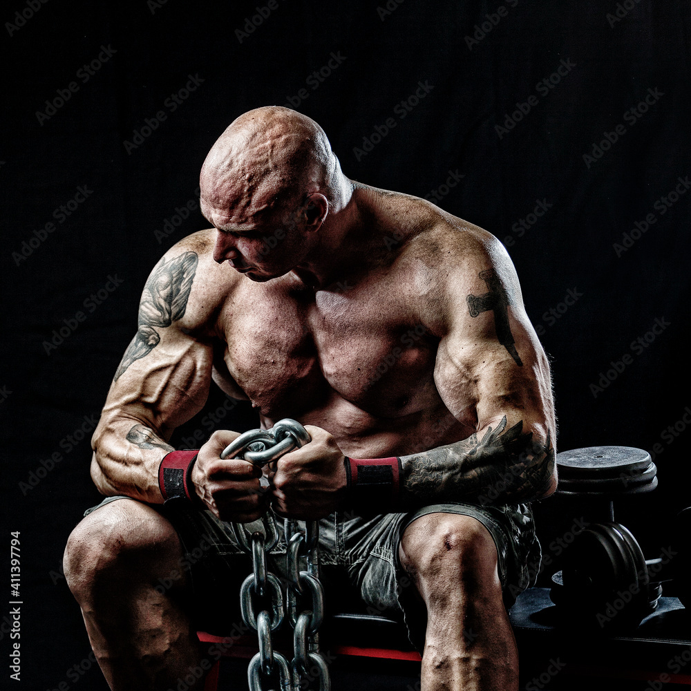 Shirtless Muscular Man Sitting Against Black Background Stock Photo ...