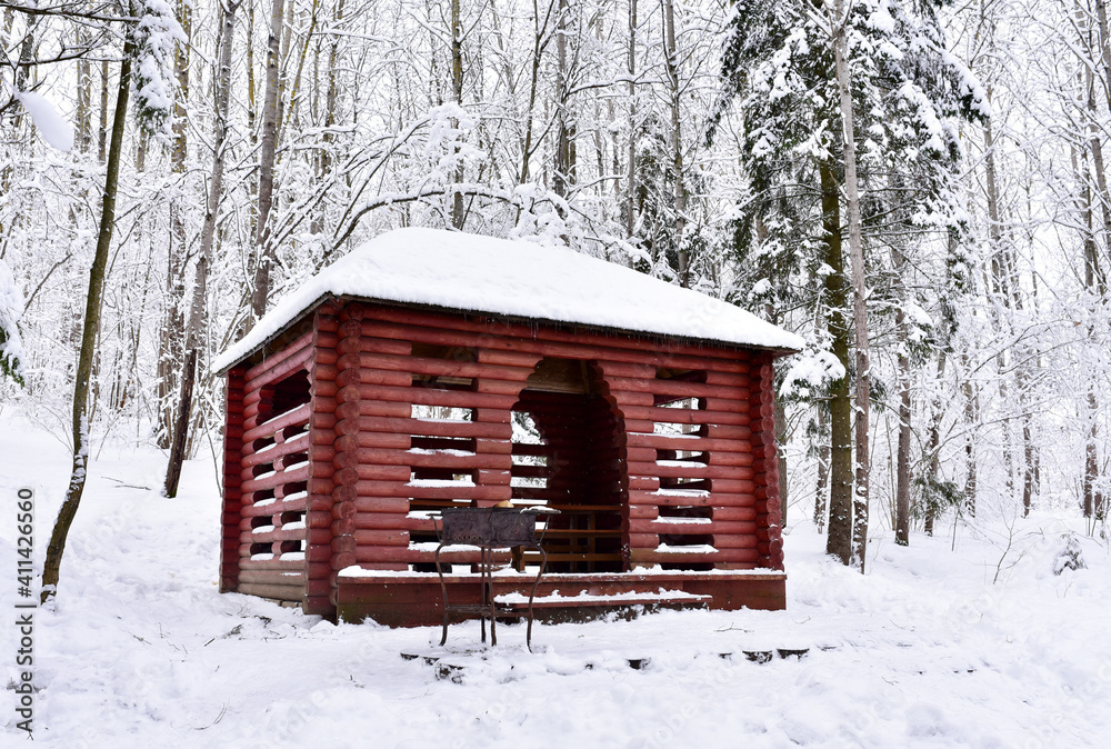 Wooden gazebo for relaxation and barbecue. Log cabin in forest for ...