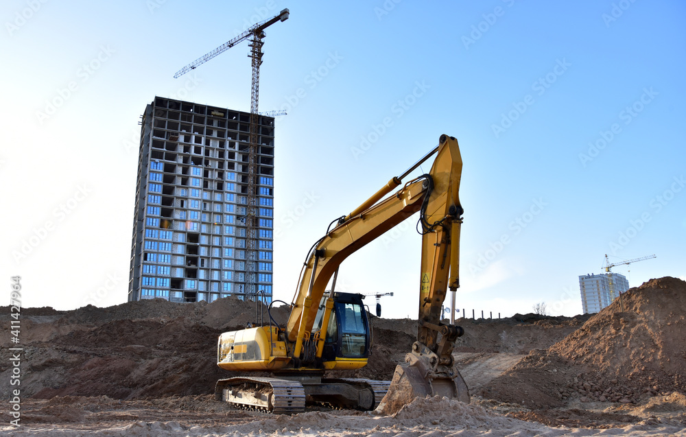 Excavator dig trench at construction site. Digging the pit foundation ...