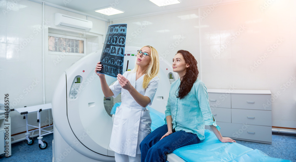 Radiologist with a female patient examining a CT scan Stock Photo ...