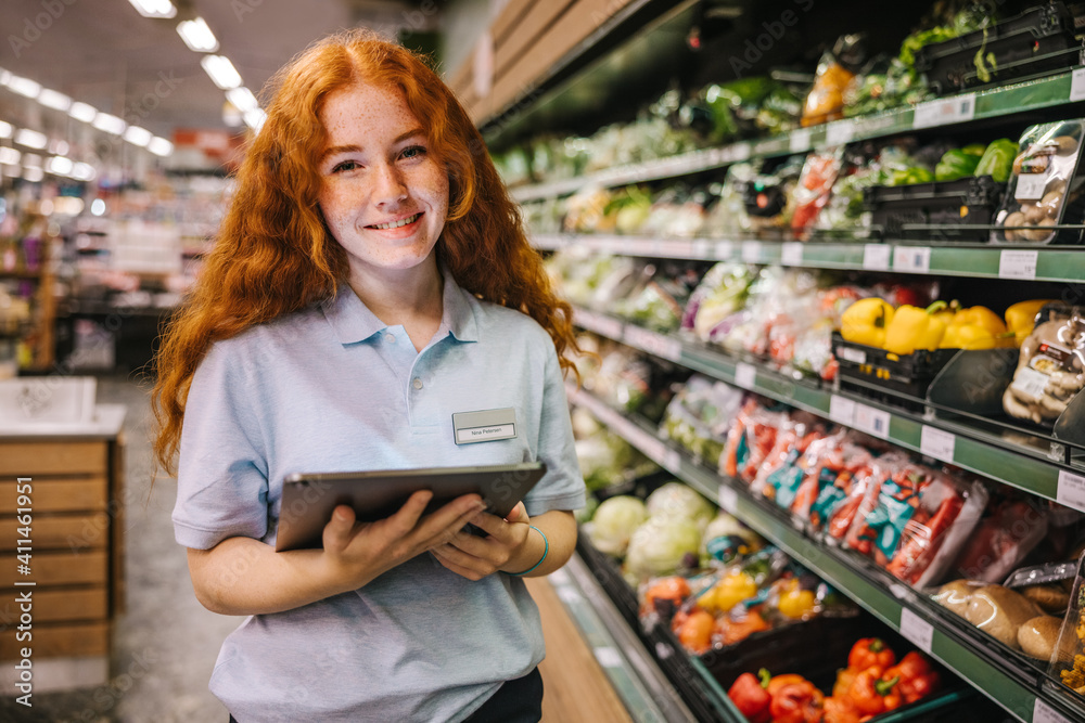 Young worker working in a supermarket Stock Photo | Adobe Stock