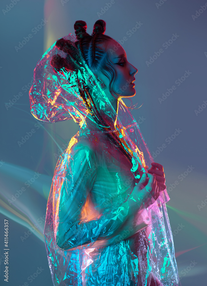 Young model posing in rain coat and creative hair style Stock Photo ...