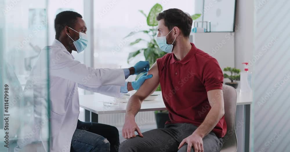 Young caucasian male patient visiting doctor for vaccoination process ...