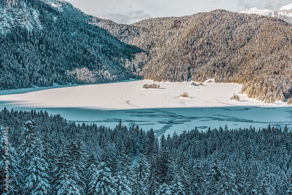 snowy mountains and trees in the alps. View of the lake Eibsee. Germany ...