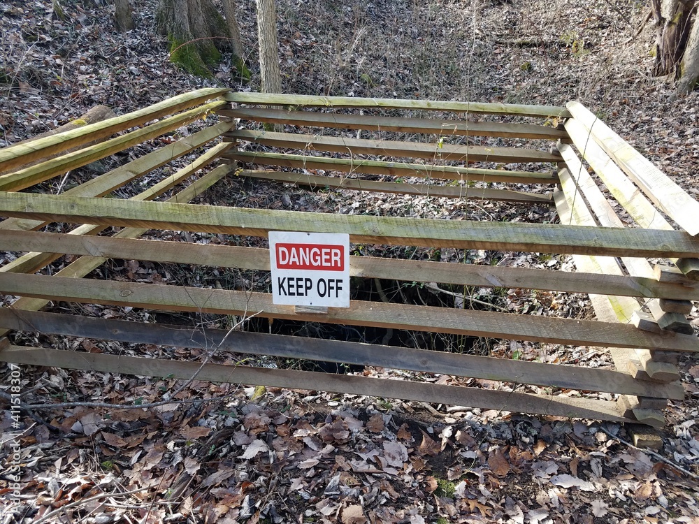 danger keep off sign on wood fence around mine entrance Stock Photo ...