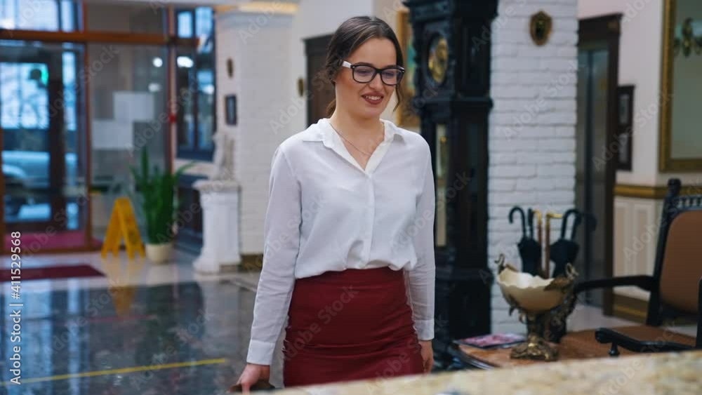 Charming lady with suitcase in the reception lobby. Girl approaching ...