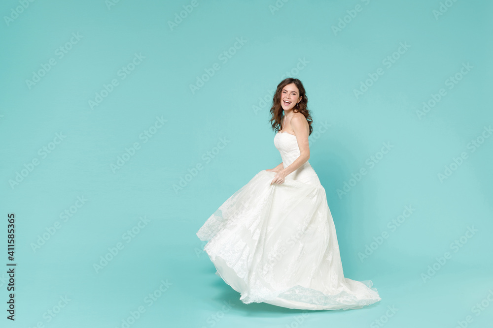Full length side view of laughing bride woman 20s in beautiful white ...