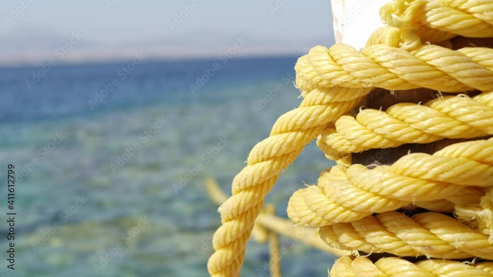 Mooring bollard and tethered rope on the shore of a sea vídeo do Stock ...