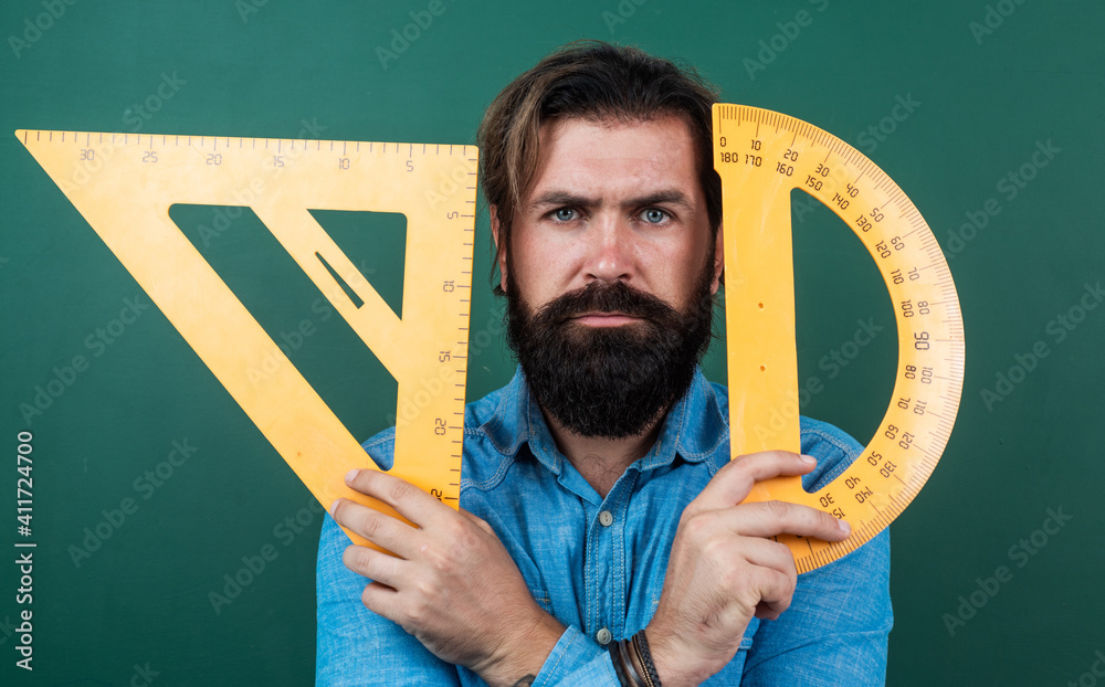 formal education. measure and size. serious teacher hold triangle and ...