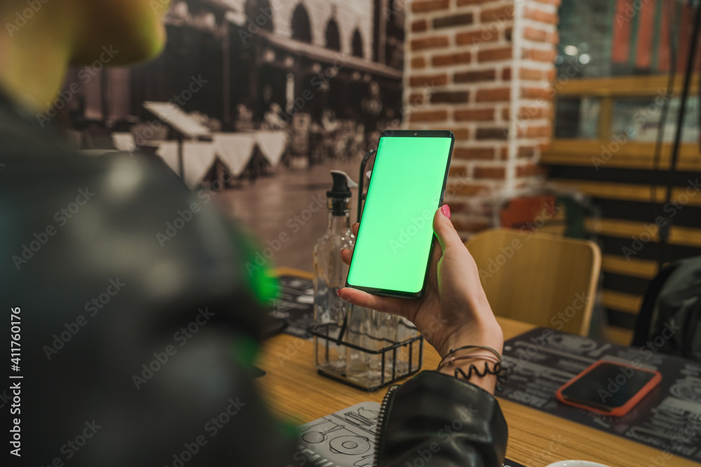 Using smartphone with green screen in coffee shop Stock Photo | Adobe Stock
