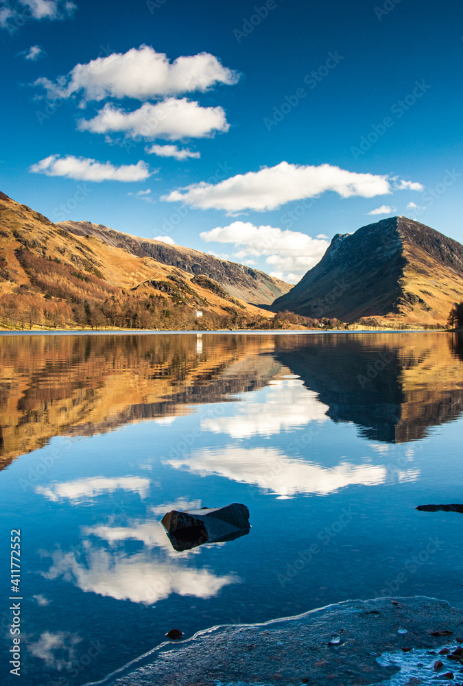 Mirror like reflections on Buttermere in the Lake District (portrait ...
