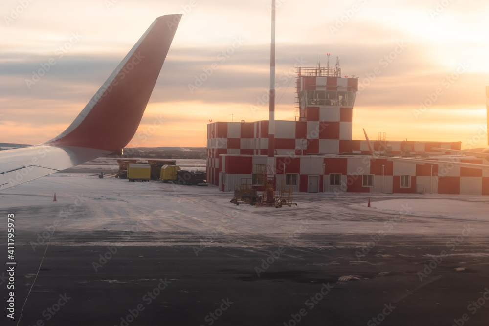 airport building at dawn on the runway with flashing beacon painted in ...