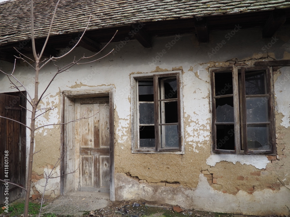 Old house with windows and a door. Collapsing rural house. The concept ...