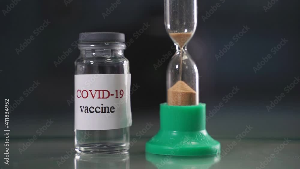 vaccine vial and the concept of an hourglass, it's time for vaccination ...