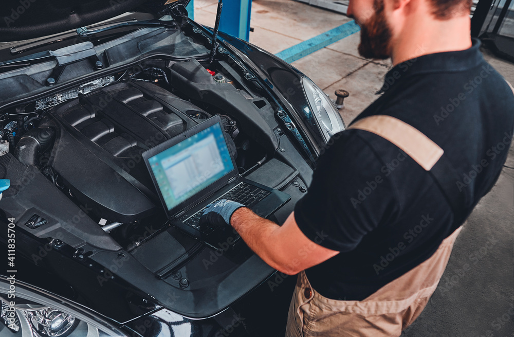 Mechanic using Diagnostic machine tools ready to be used with car ...