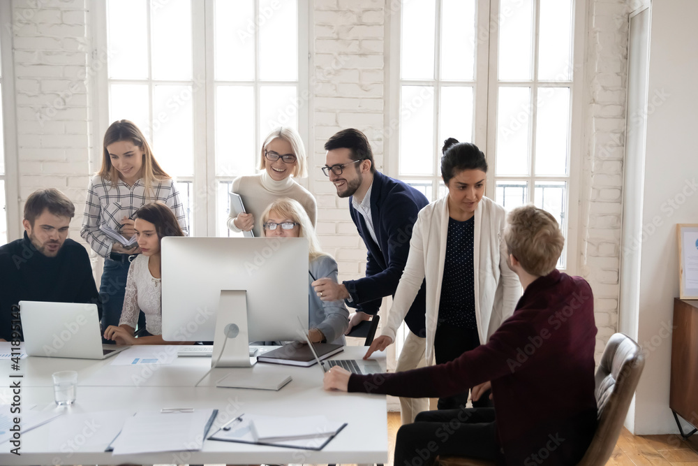 Diverse group of millennial professionals working on project at ...