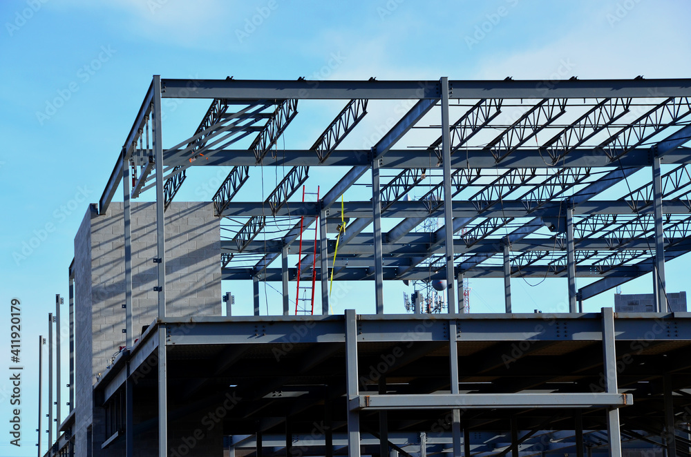 Two story steel frame commercial building under construction in urban ...