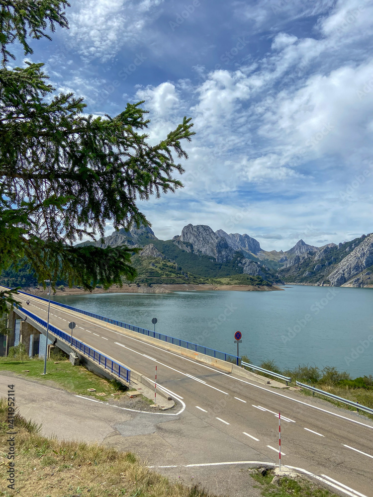 Bridge over the Riano reservoir in Northern Spain. Yordas Peak towers ...