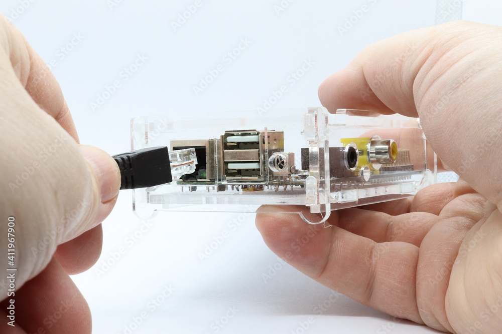 Hands connecting a computer network cable to a mini PC Stock Photo ...
