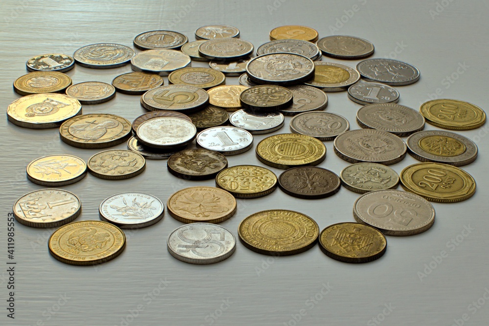 coins of different countries and denominations on painted table Stock ...