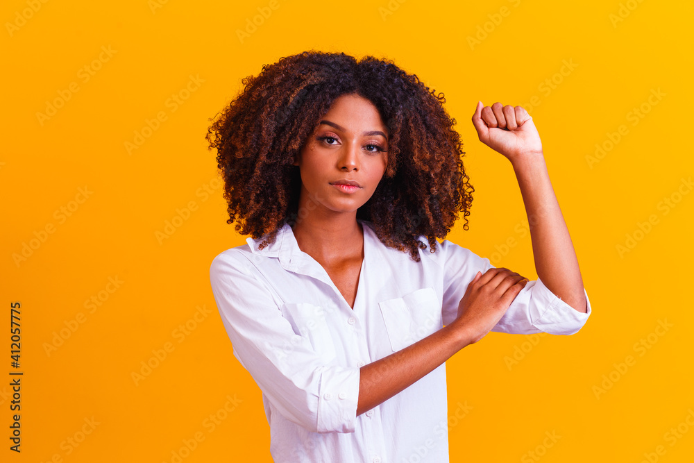 We can do it. Woman's fist of female power. Woman victim of racism ...