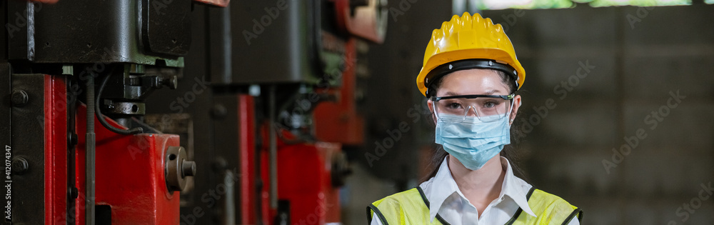 woman engineering wear protection face mask and safety helmet holding ...