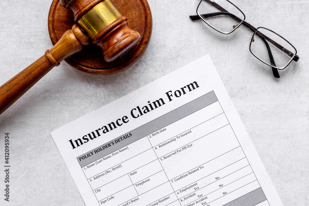 Insurance claim form with judge gavel . Top view Stock Photo | Adobe Stock
