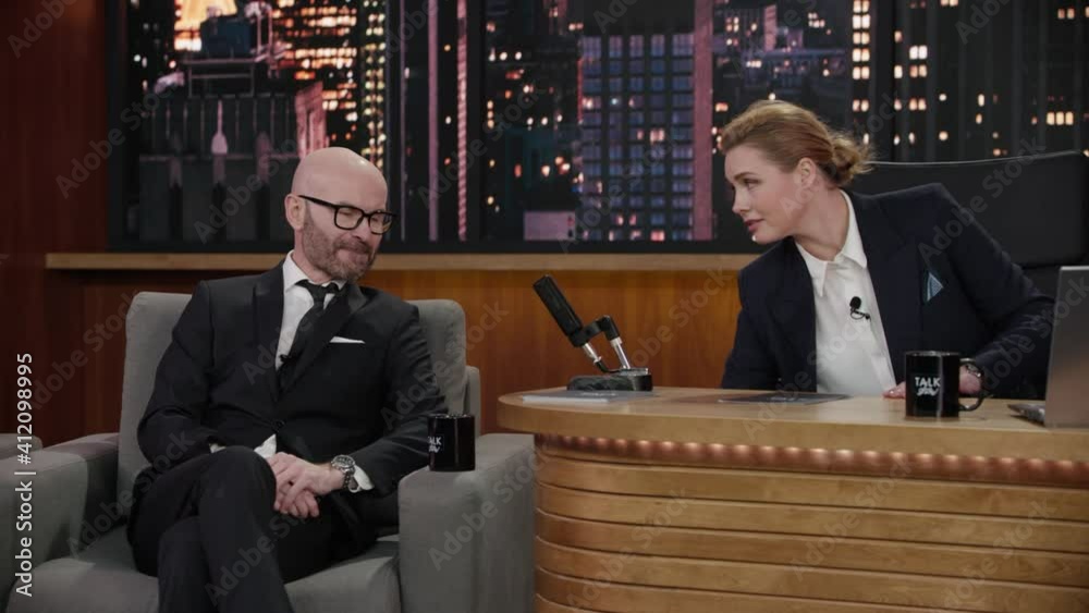 ZOOM IN television like, late-night talk show female host having a ...