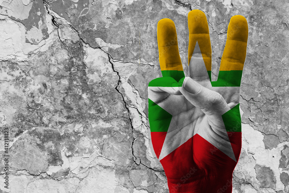 The 3-finger raised as a protest sign with a painted flag of Myanmar ...