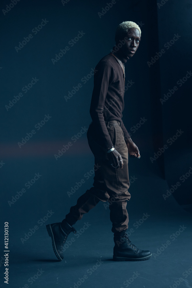 full-length photo in the studio of a dark-skinned handsome guy with ...