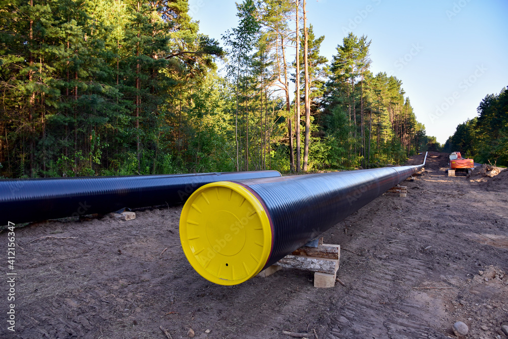 Natural gas pipeline construction work in forest area. Petrochemical ...