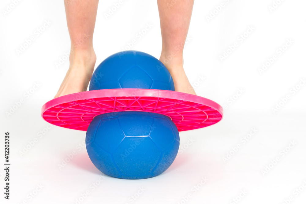 Kids legs on balance trainer isolated on white background. Bouncy ball ...