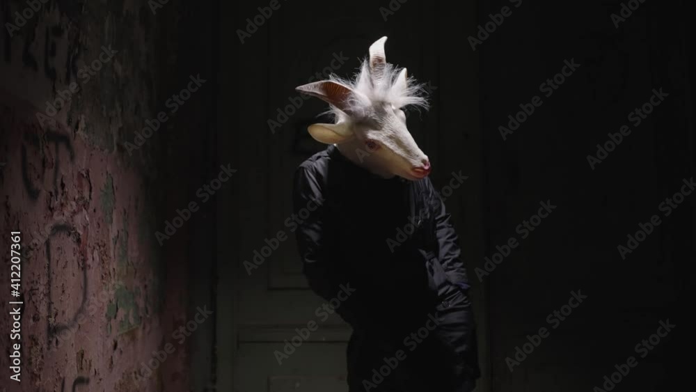 Scary, masked stranger waiting in the dark. Eerie, horror scene with a ...