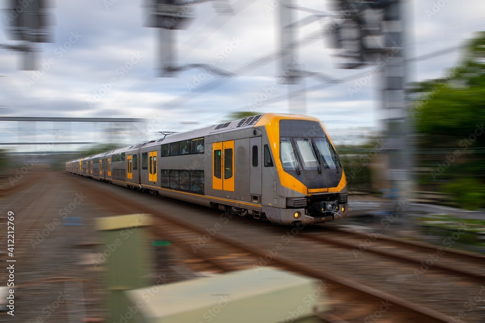 Sydney Train heading through Summerhill Station with background motion ...