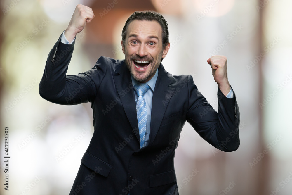 Happy boss rejoicing and celebrating with his hands up. Standing ...